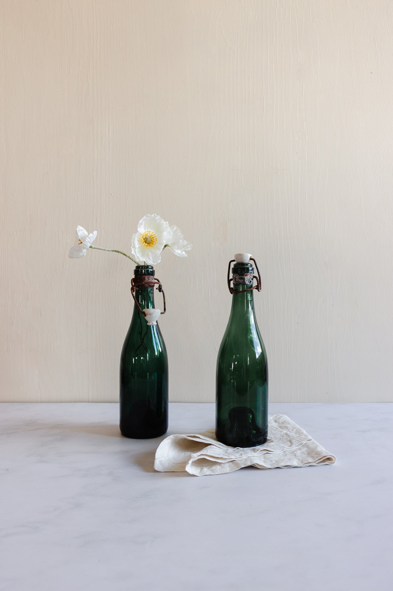 pair of vintage french green glass porcelain top bistro bottles – Joliette